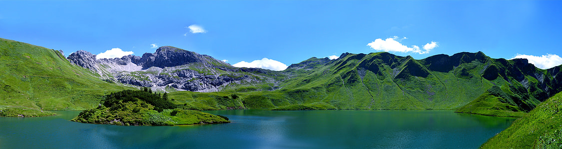 Royalty-Free photo: Blue calm body of water near mountain at daytime ...